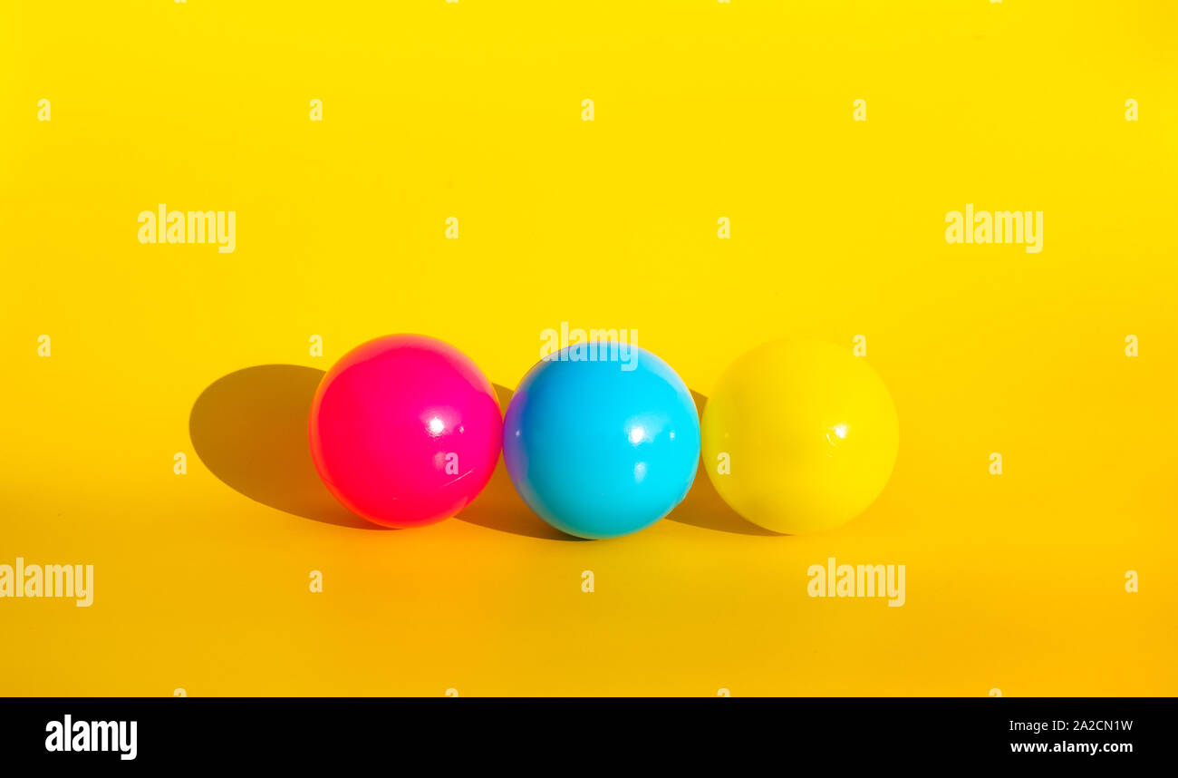 Colorful balloon with shadow on yellow color background.party and ...
