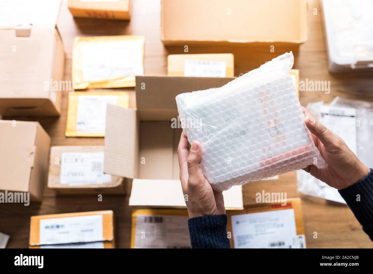 Online shopping concepts with male hand packing some product to brown ...