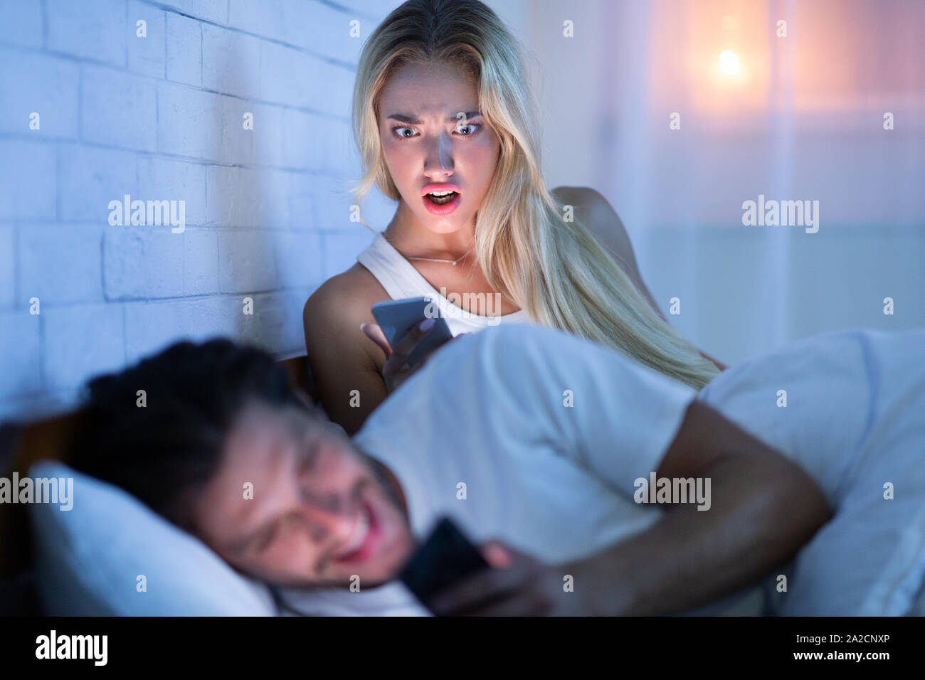 Jealous Girlfriend Catching Boyfriend Texting With Women Lying In Bed ...