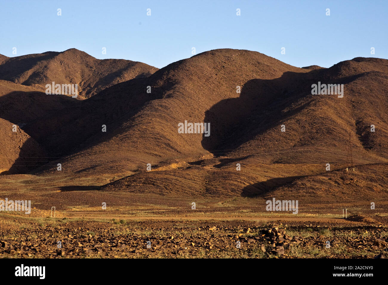 Young Moroccans play soccer on a remote land field located in the Dra ...