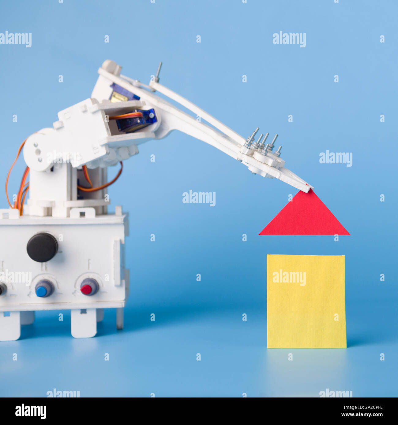 Robot hand building house of wooden blocks Stock Photo - Alamy