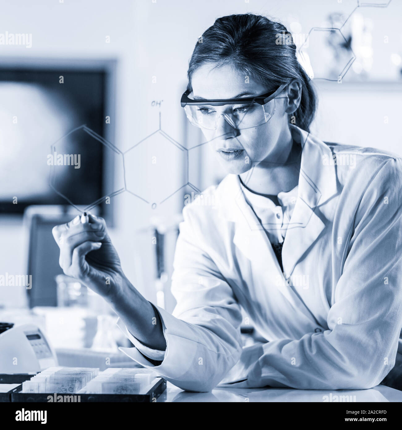Portrait of a confident female researcher in life science laboratory ...
