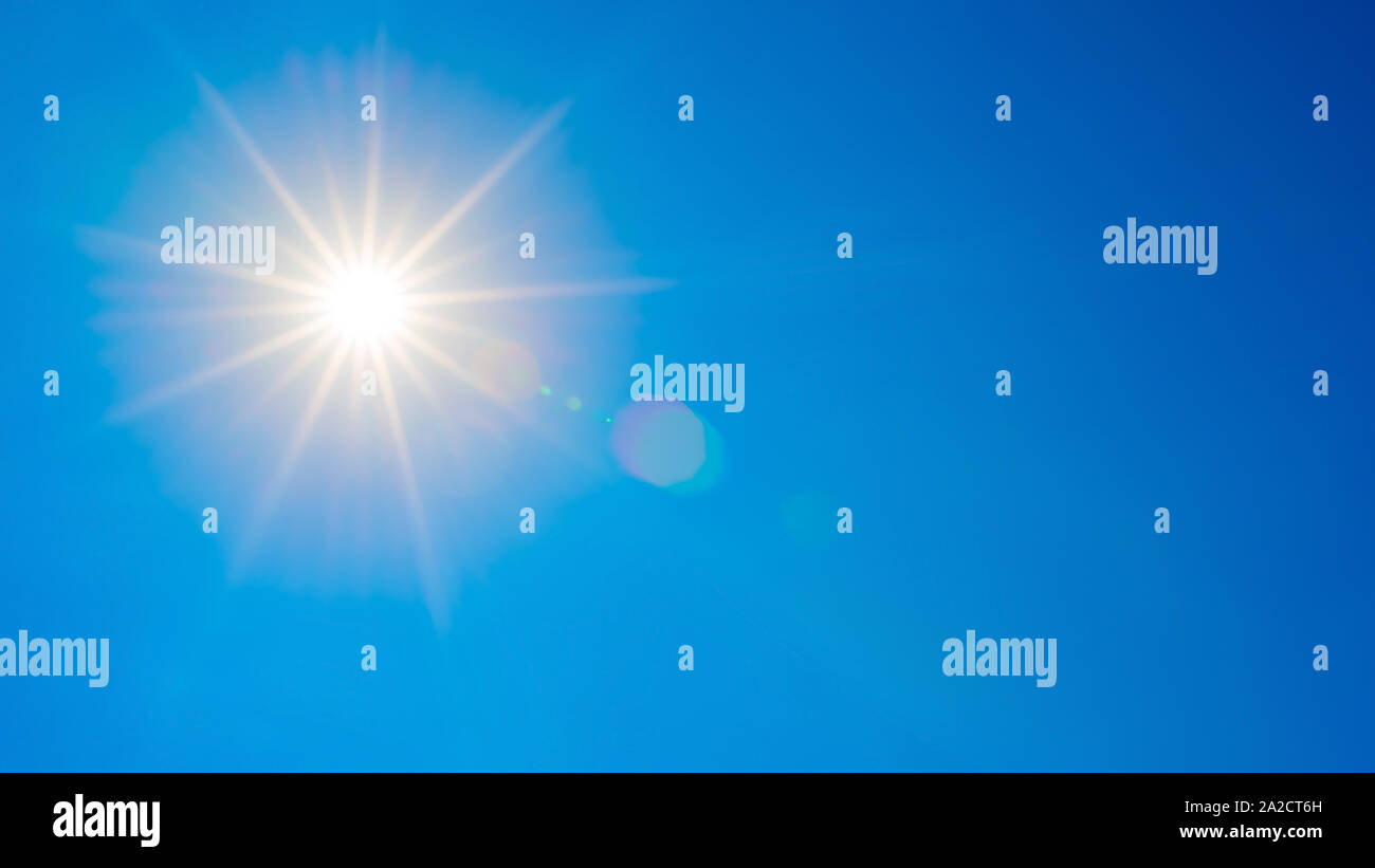 Blue sky with bright sun Stock Photo - Alamy