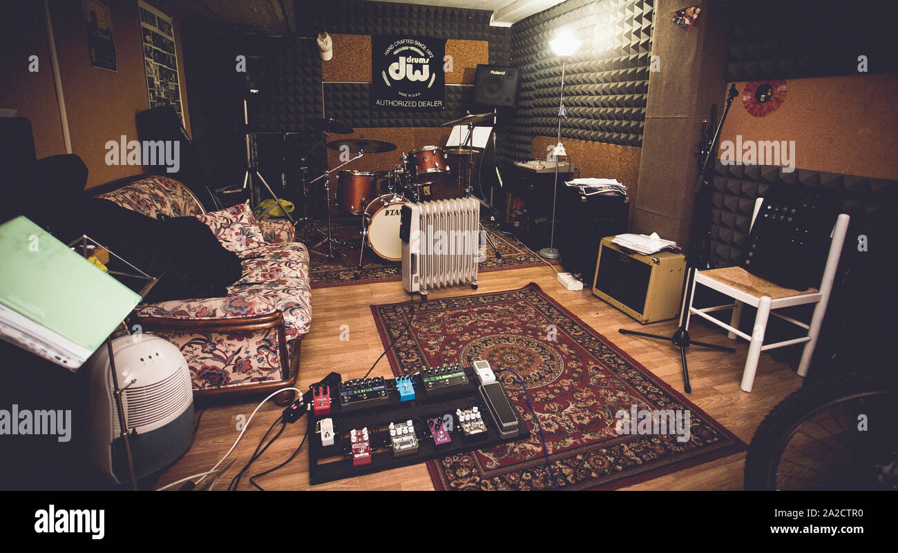 Small home rehearsal room in a soundproof box with amplifier, drums ...