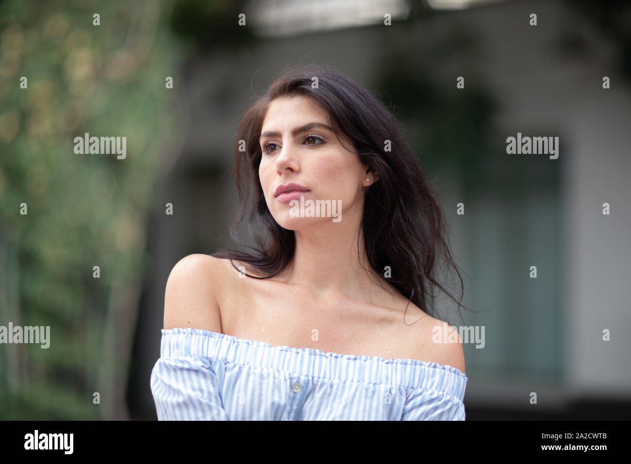 A portrait of a lovely romantic young woman outdoors, inspiringly ...