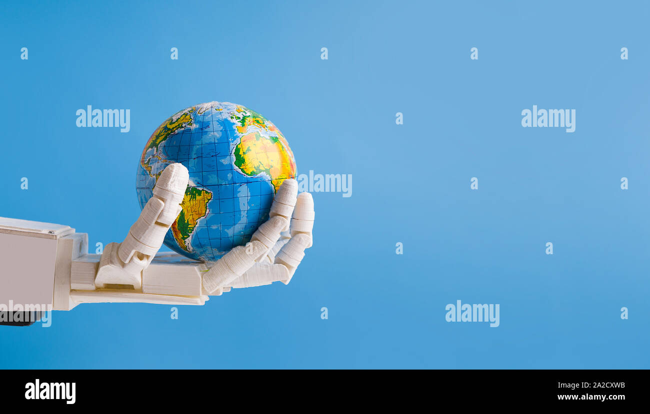 Robot holding Earth globe in hand, blue panorama background Stock Photo ...