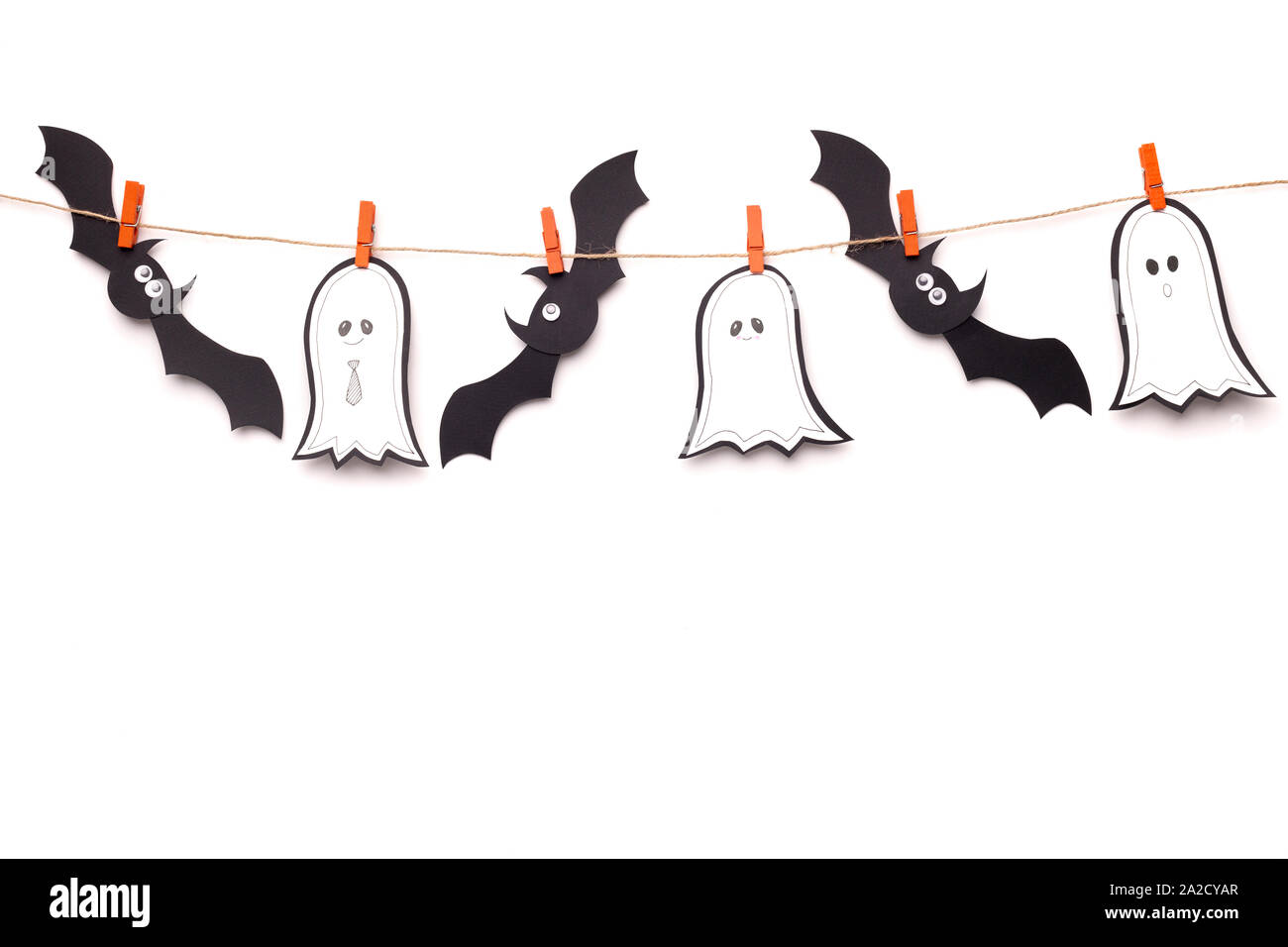 Flying black bats and ghosts hanging on rope on white Stock Photo - Alamy