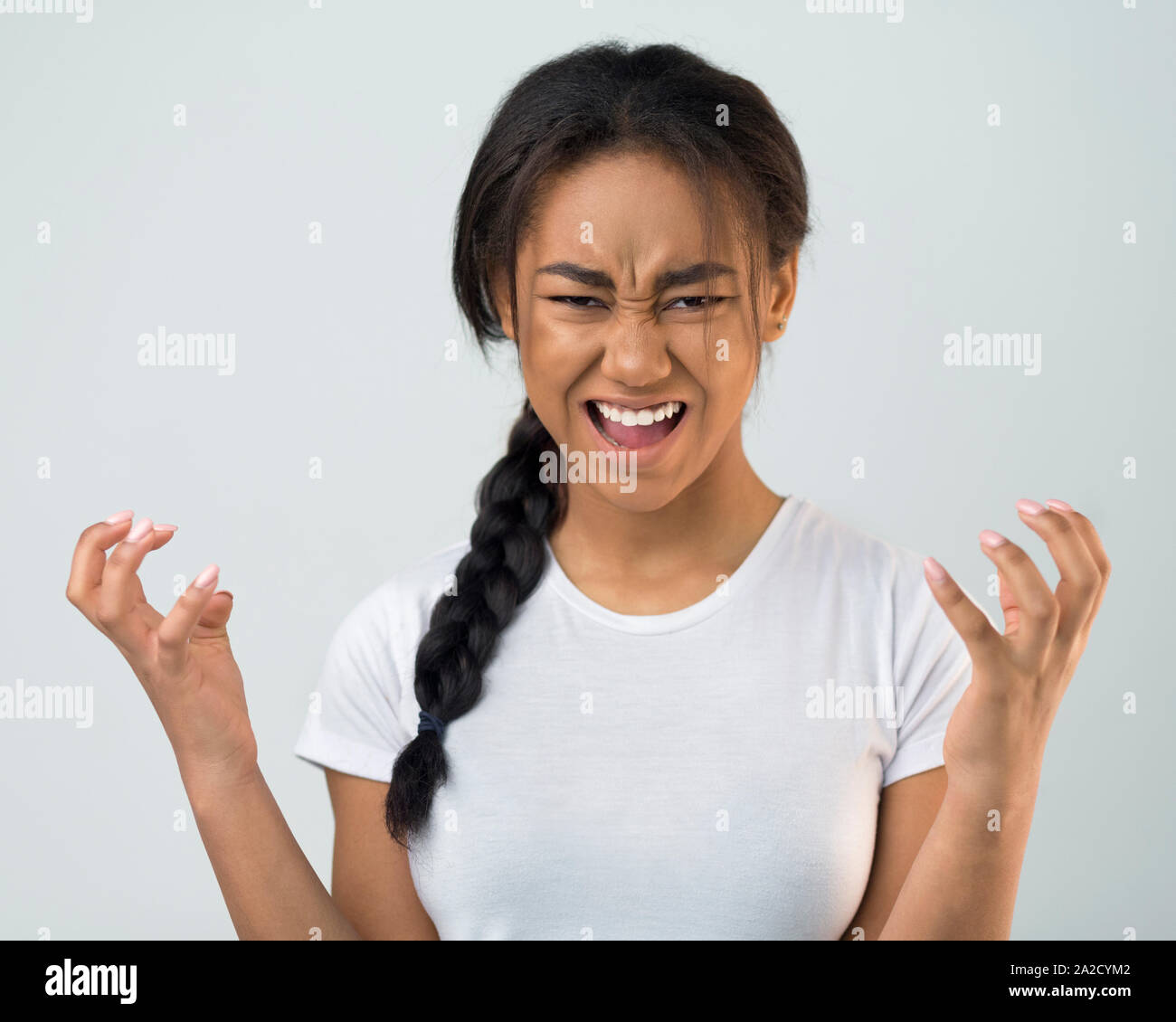 Annoyed angry woman holding hands in furious gesture Stock Photo - Alamy