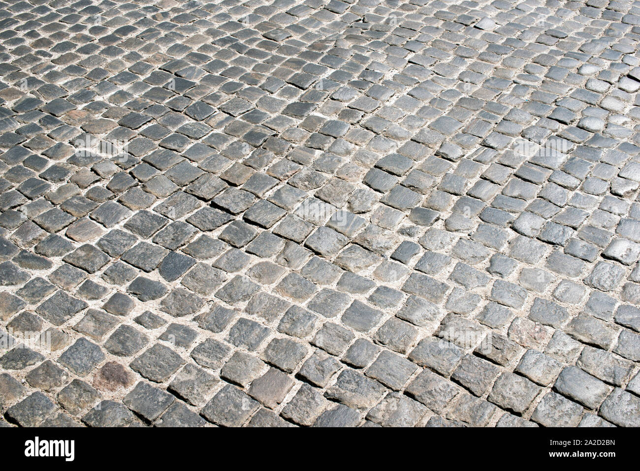 ancient cobblestone pavement pattern in Warsaw by bright sunny day ...
