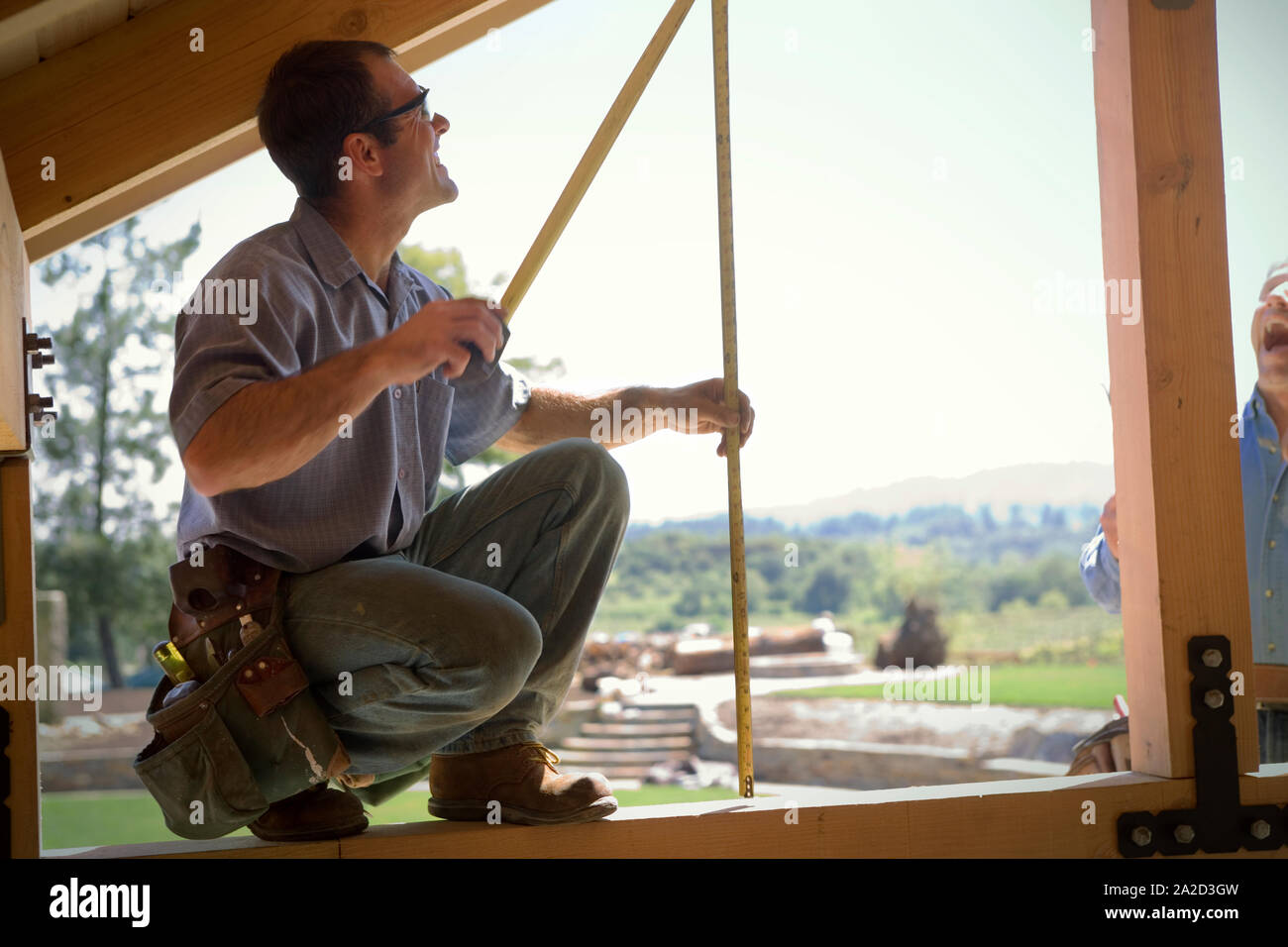 Builder measuring height tape measure hi-res stock photography and ...