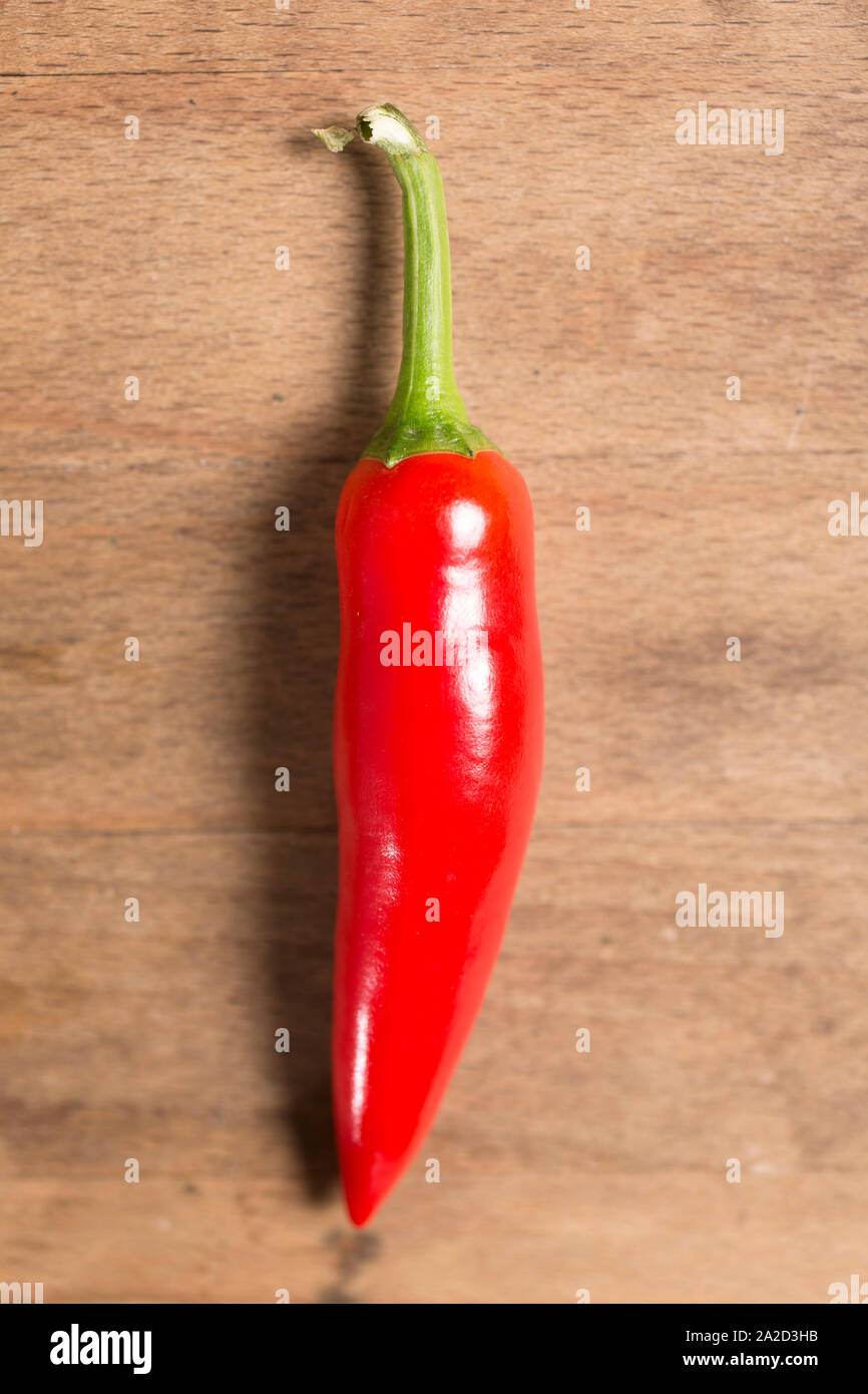 Fesh red chilli on a wooden kitchen work surface Stock Photo - Alamy