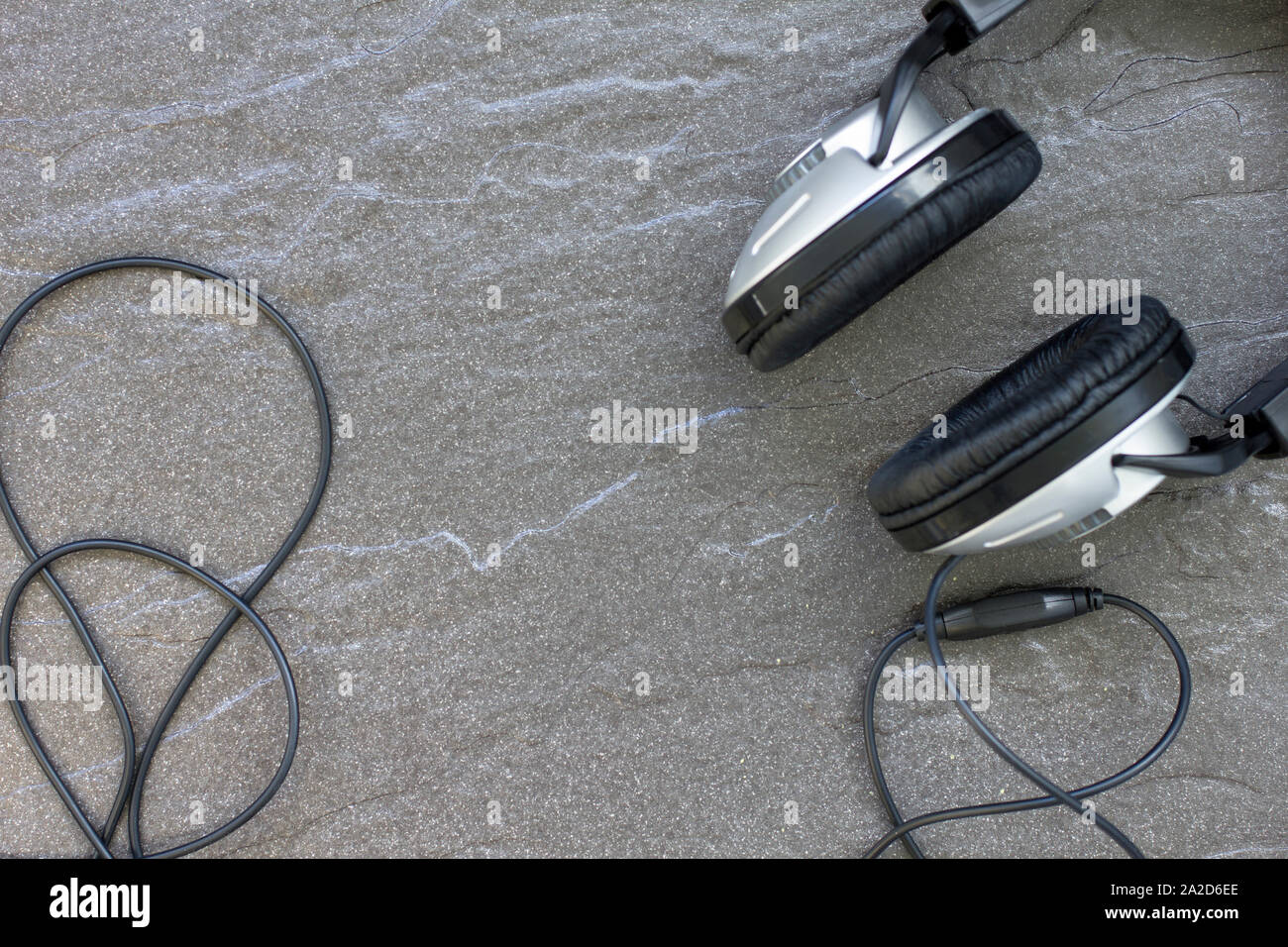 Music headphones on a detailed stone surface Stock Photo - Alamy