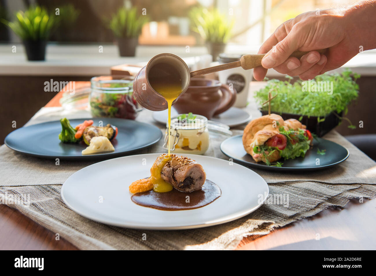 Chef pouring with sause meat roll Stock Photo - Alamy