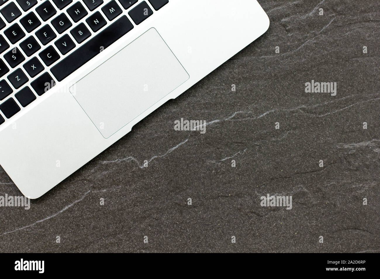 Laptop computer on a stone table with a modern look Stock Photo - Alamy