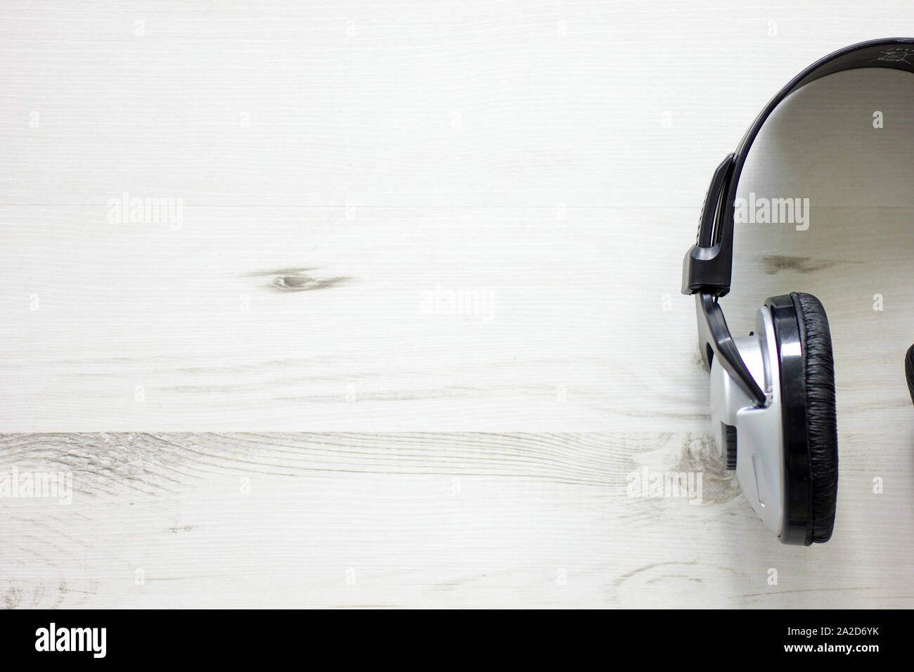 Headphones border a wood surface background Stock Photo - Alamy