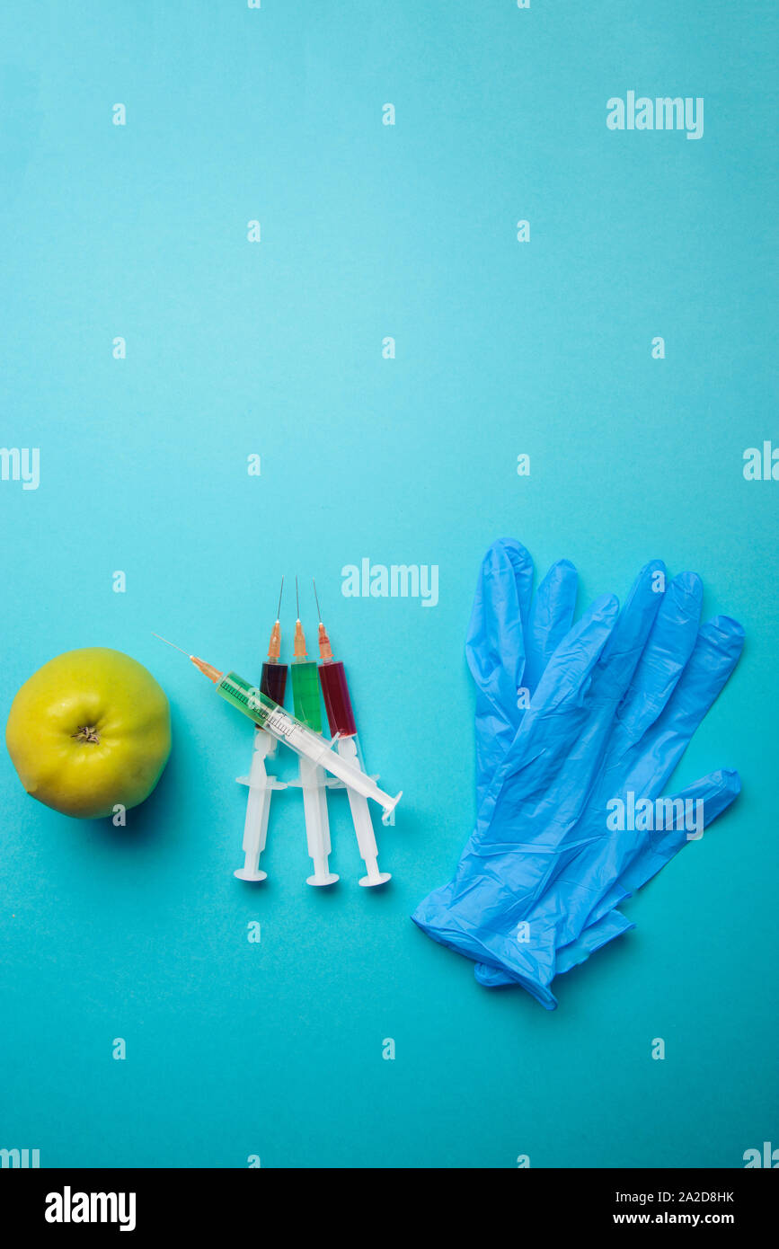 Chemical additives in food or genetically modified fruit concept. Green ...