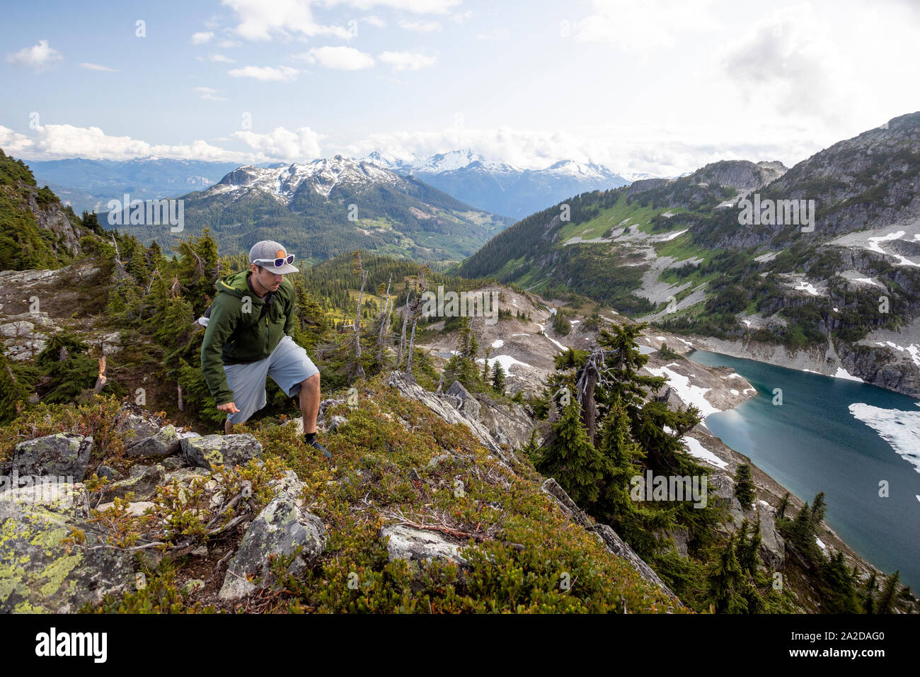 A man hikes along an alpine ridge in the mountains Stock Photo - Alamy