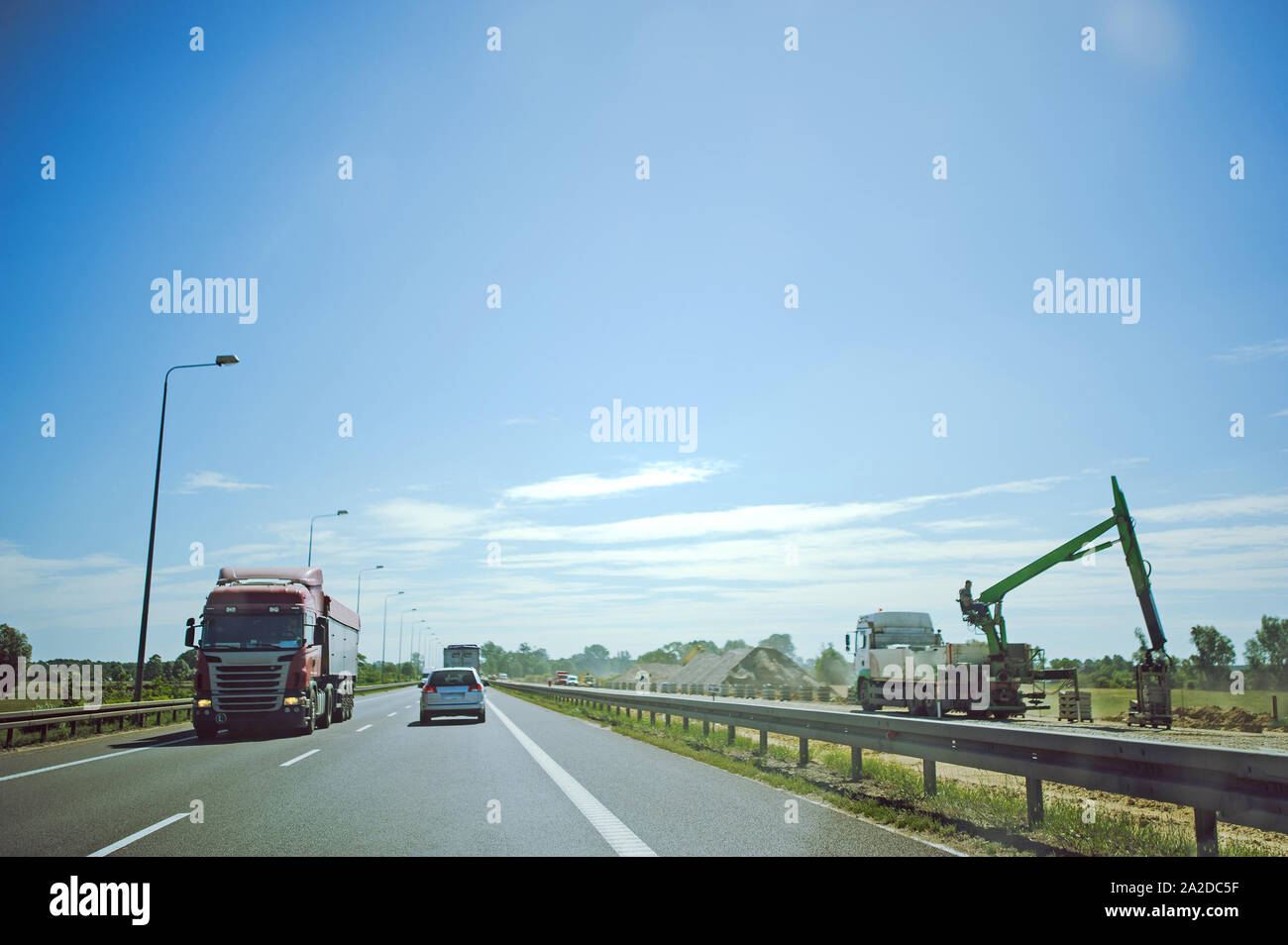 traffic on the freeway with cars and trucks overtaking. road works ...