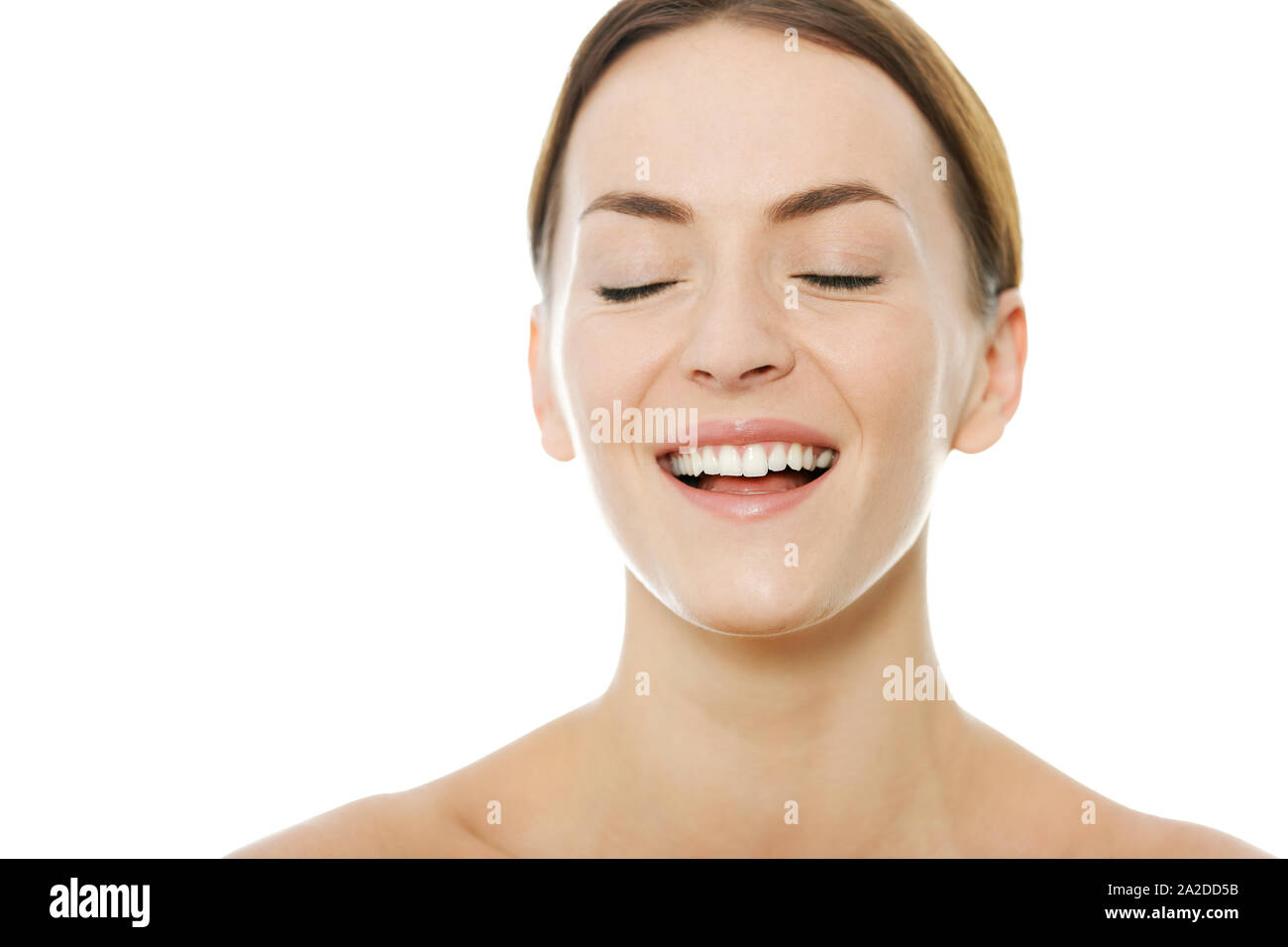 Attractive young woman in a beauty style pose laughing Stock Photo - Alamy