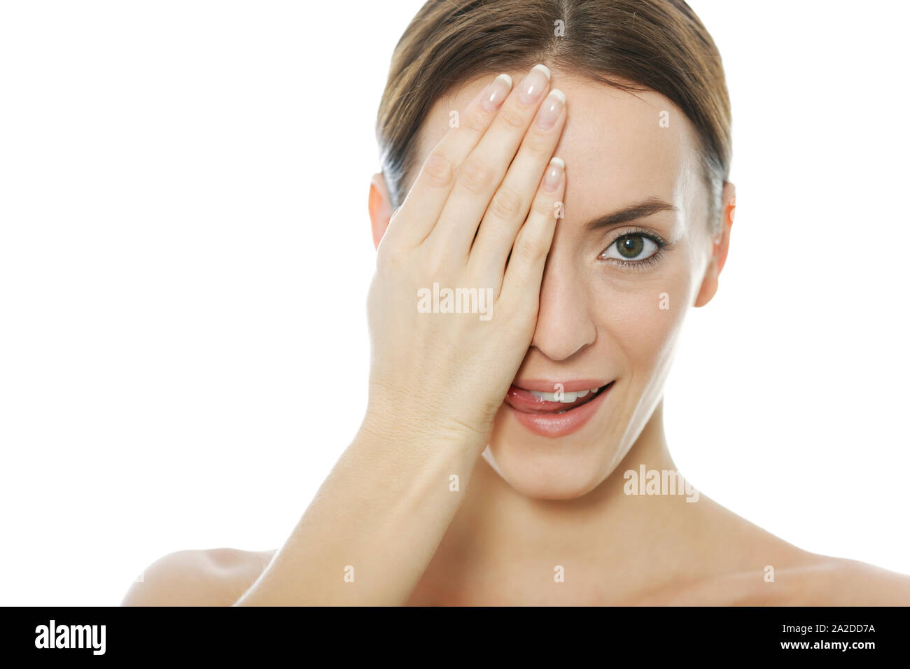 Attractive young woman covering one eye with her hand Stock Photo - Alamy