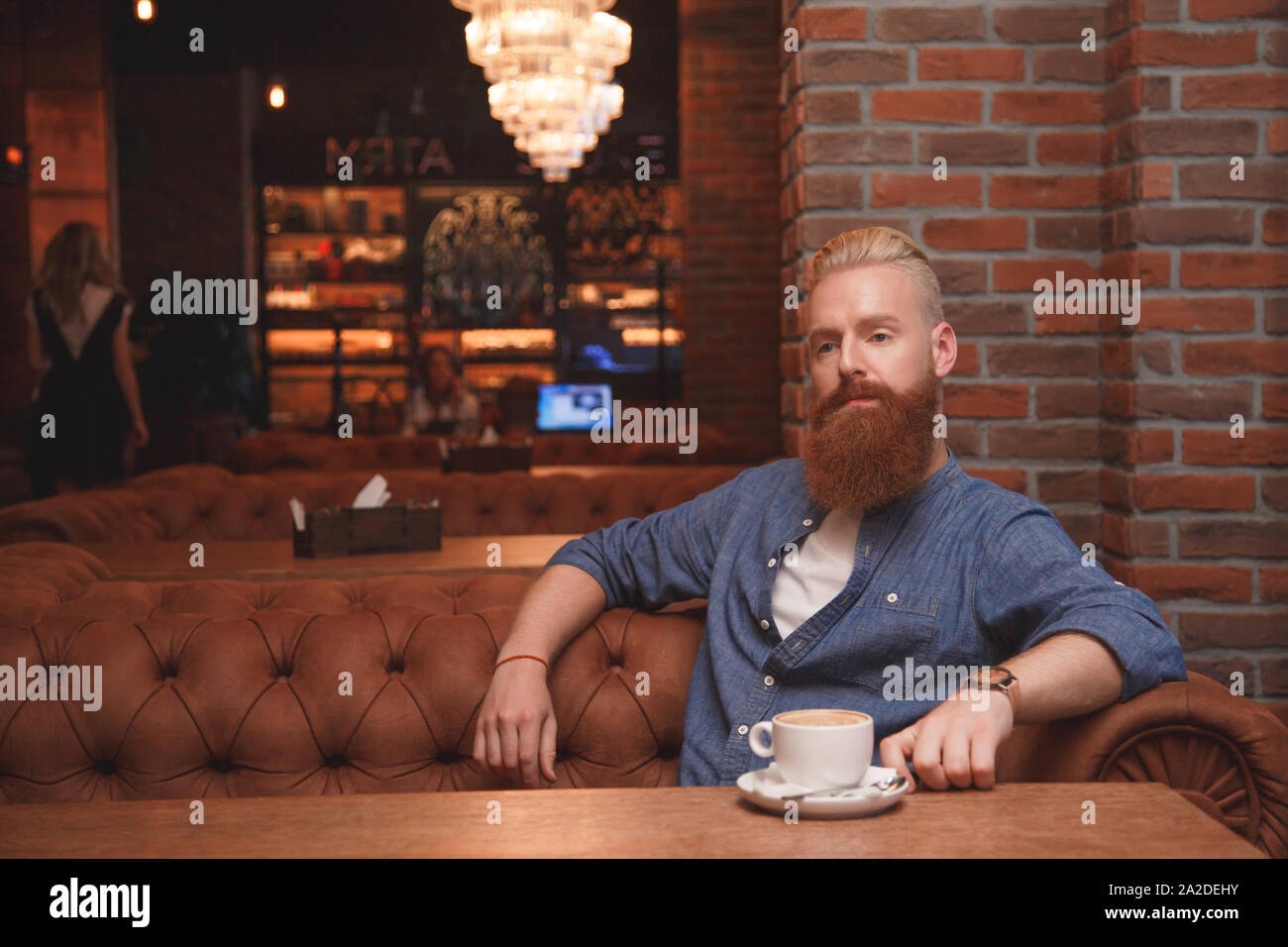 Young bearded man sitting alone in cafe Stock Photo - Alamy Young bearded man sitting alone in cafe Stock Photo - Alamy