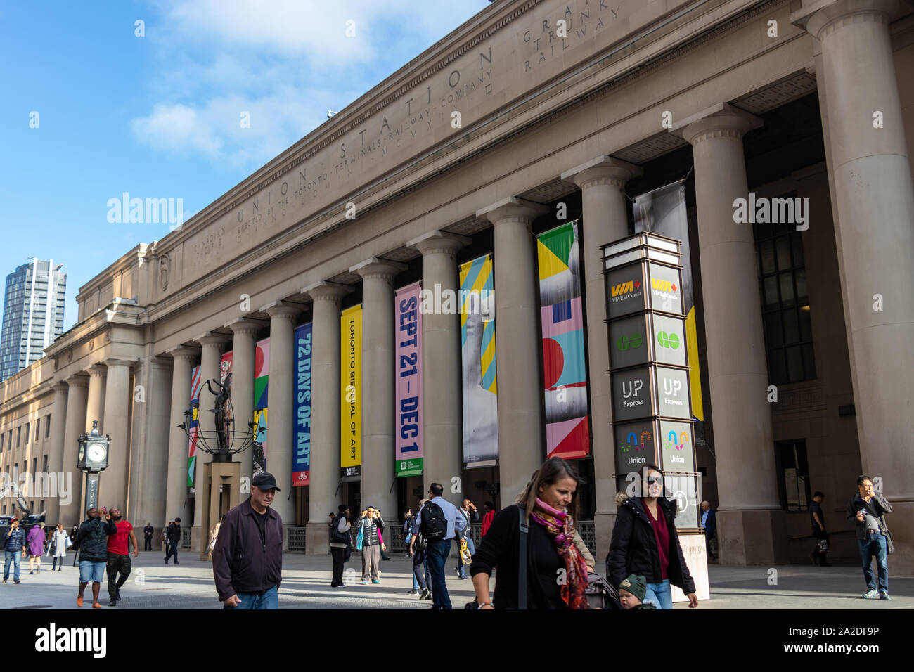 People pass by a pole with transit operators out of Toronto Union ...