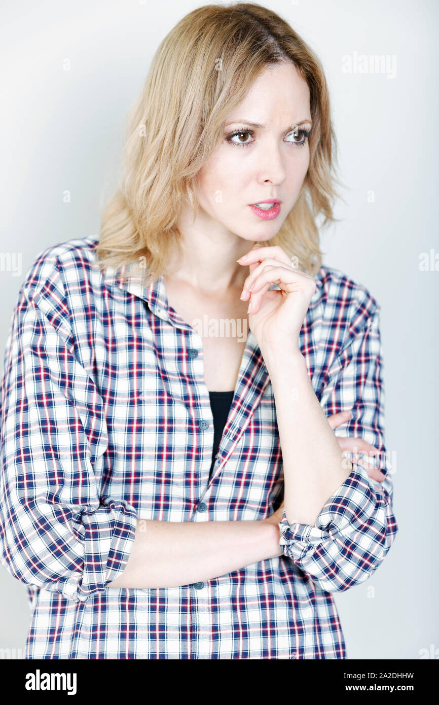 Beautiful young woman looking concerned and upset Stock Photo - Alamy