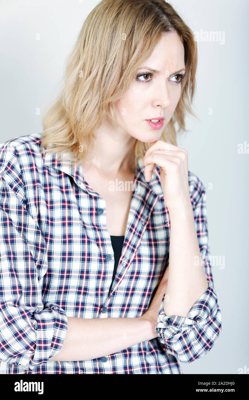 Beautiful young woman looking concerned and upset Stock Photo - Alamy