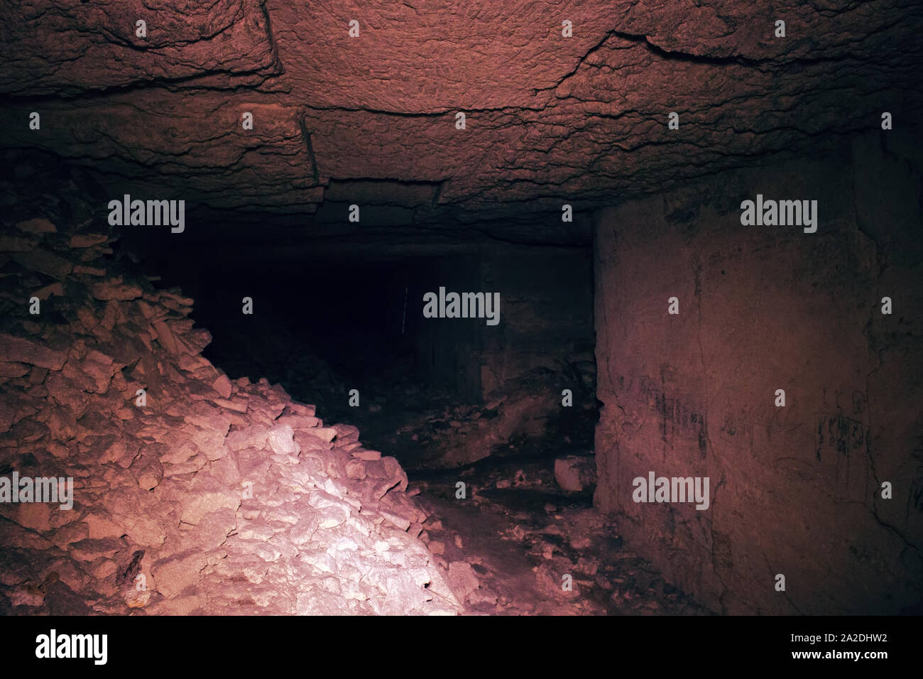 Old underground passage, dungeon, catacombs lined with stones and slabs ...