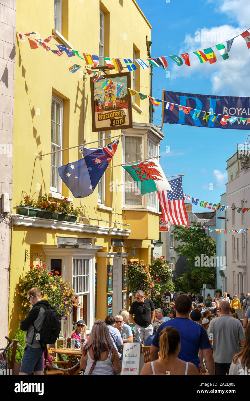 TENBY, PEMBROKESHIRE, WALES - AUGUST 2018: Crowds of people in one of ...