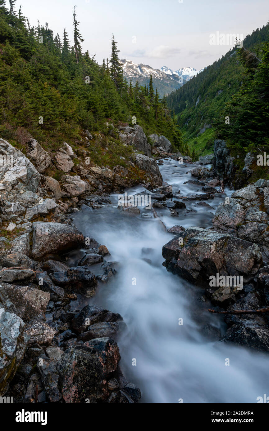 Scenic view of a creek and surrounding mountains Stock Photo - Alamy