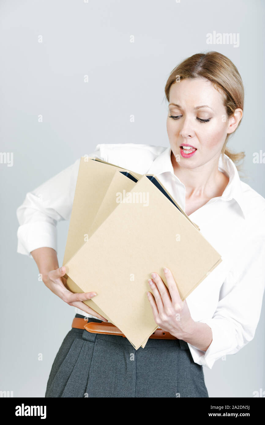 Professional business woman juggling folders and looking stressed Stock ... Professional business woman juggling folders and looking stressed Stock ...