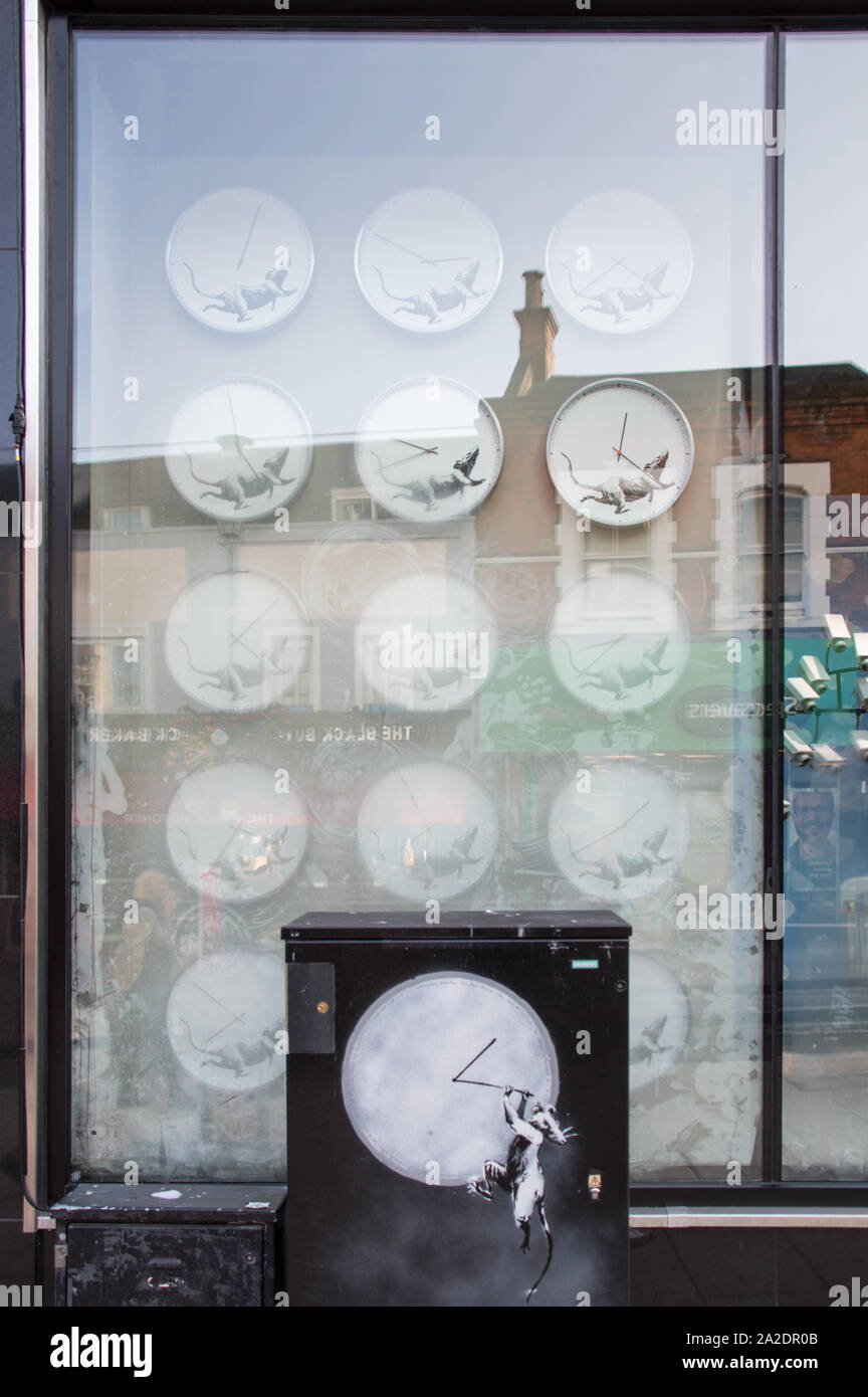 Banksy art based on clock and mouse at pop-up shop in Croydon Stock ...