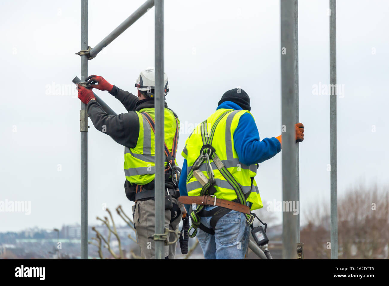 Professional Scaffolders erecting scaffolding on a building in the UK ...