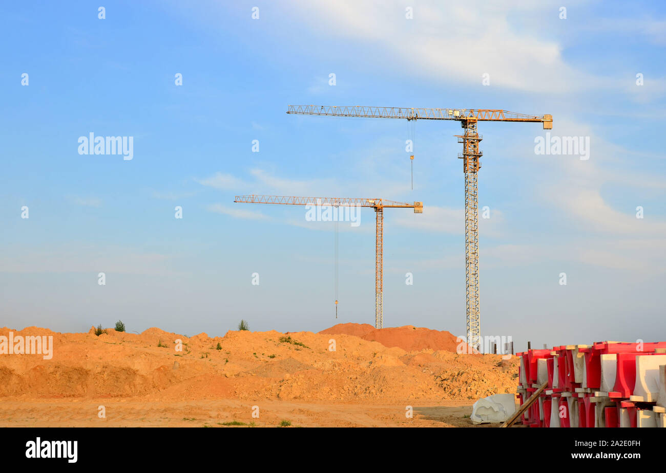 Jib construction tower cranes at a construction site on the blue sky ...