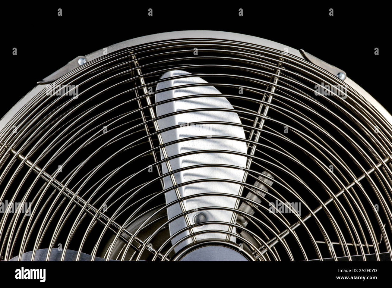 Steel desk fan isolated against a black background Stock Photo - Alamy