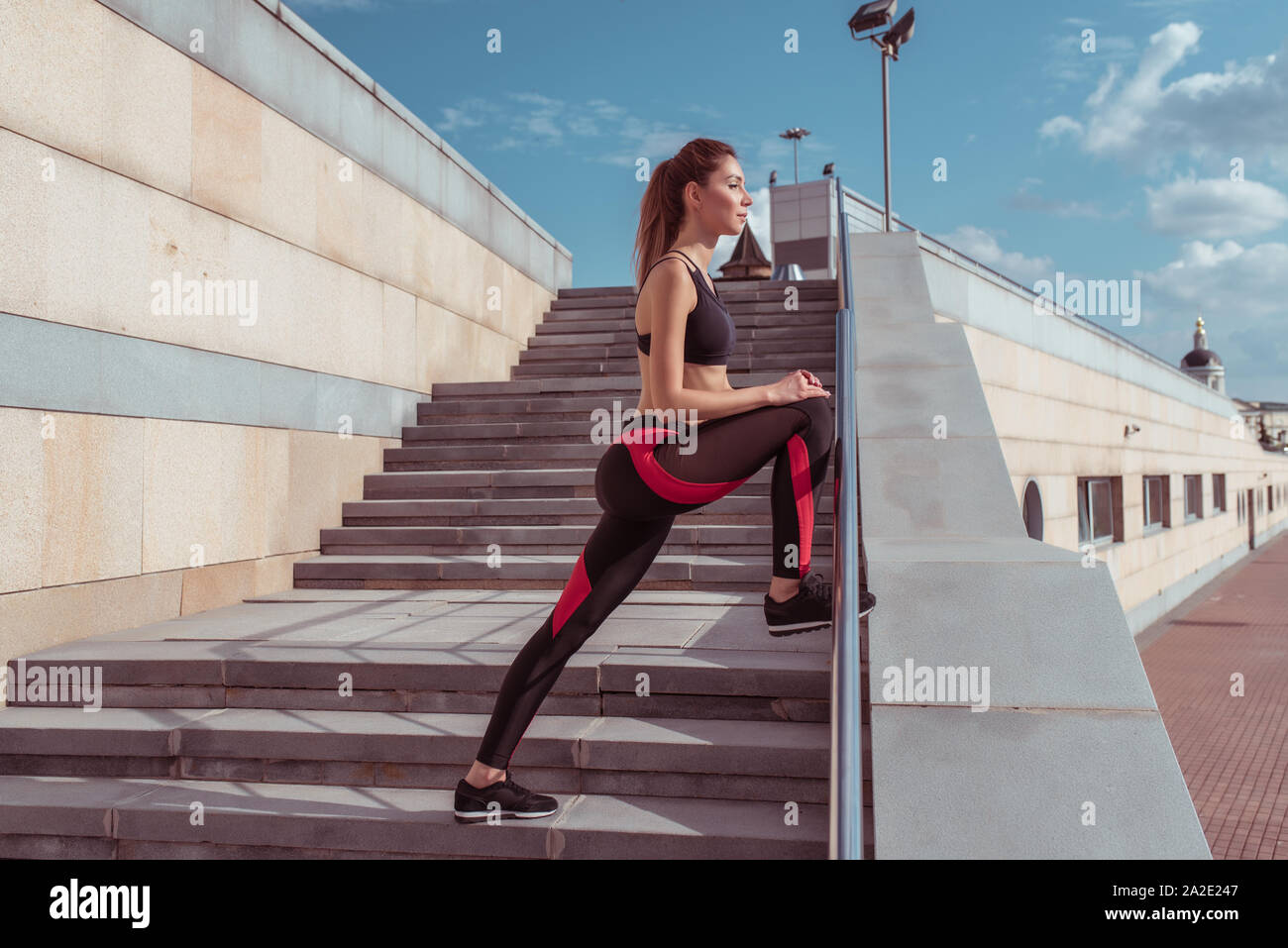 Girl athlete, athletic woman doing stretching leg muscles before ...