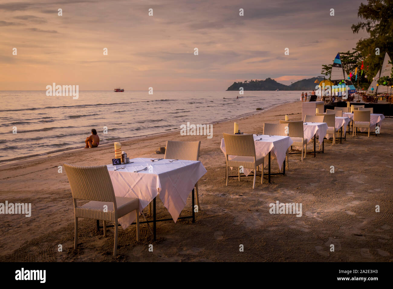 tables on beach in thailand at sunset Stock Photo - Alamy