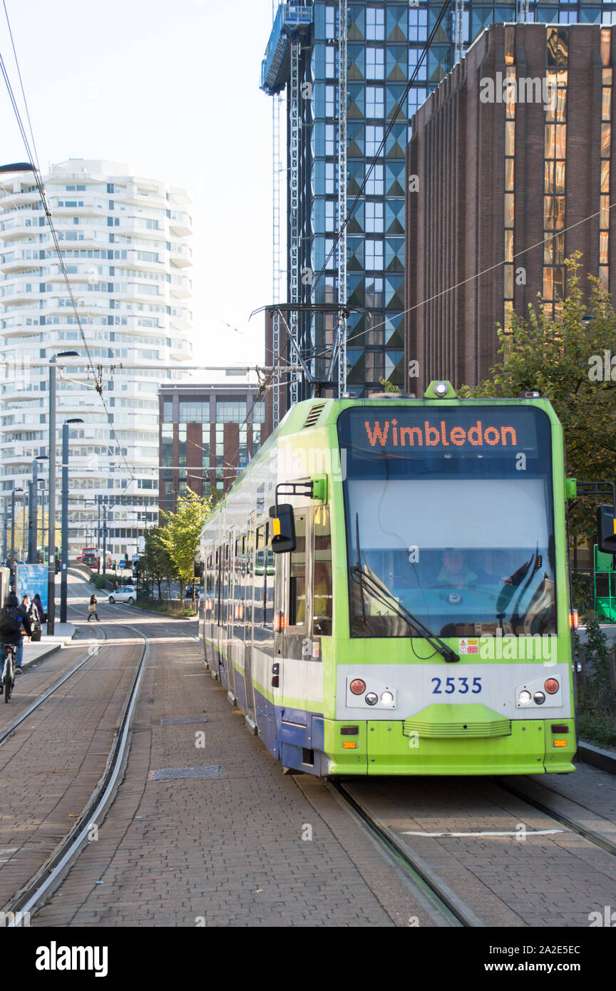 London Wimbledon tram departing East croydon station with NLA building ...