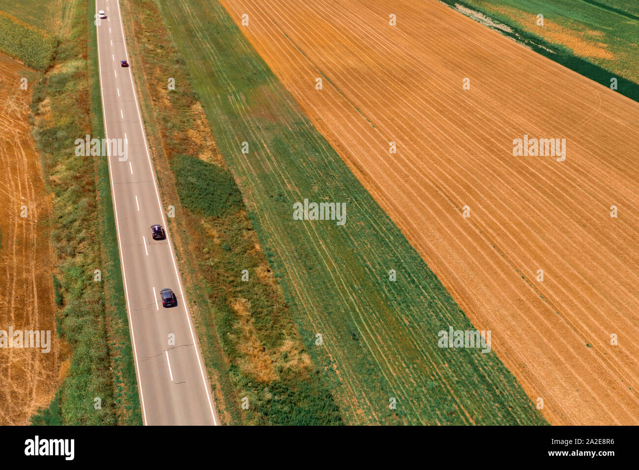 Traffic on the road through countryside landscape from drone pov ...