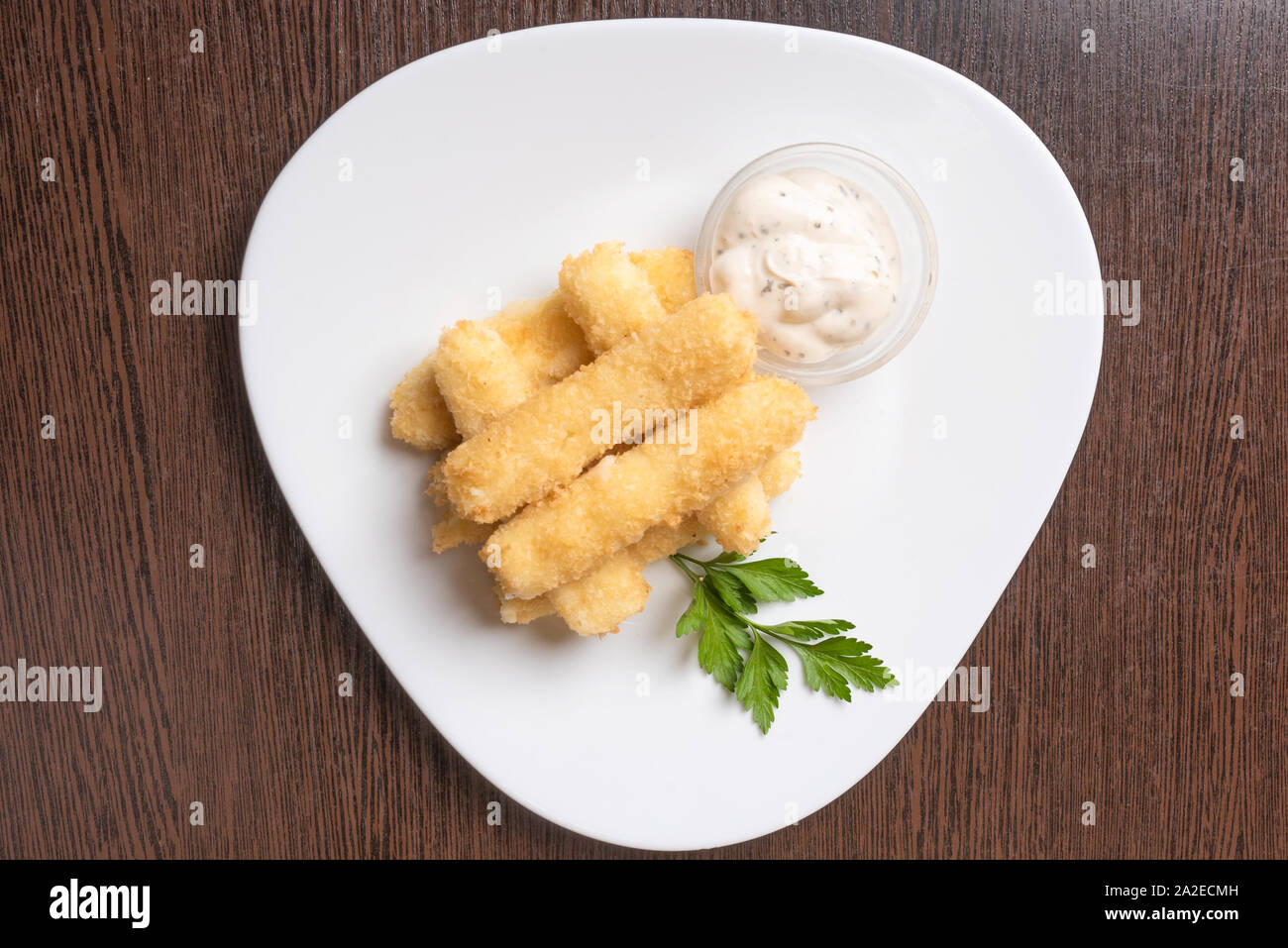 Cheese sticks breaded, with sauce and herbs, on a platter Stock Photo ...