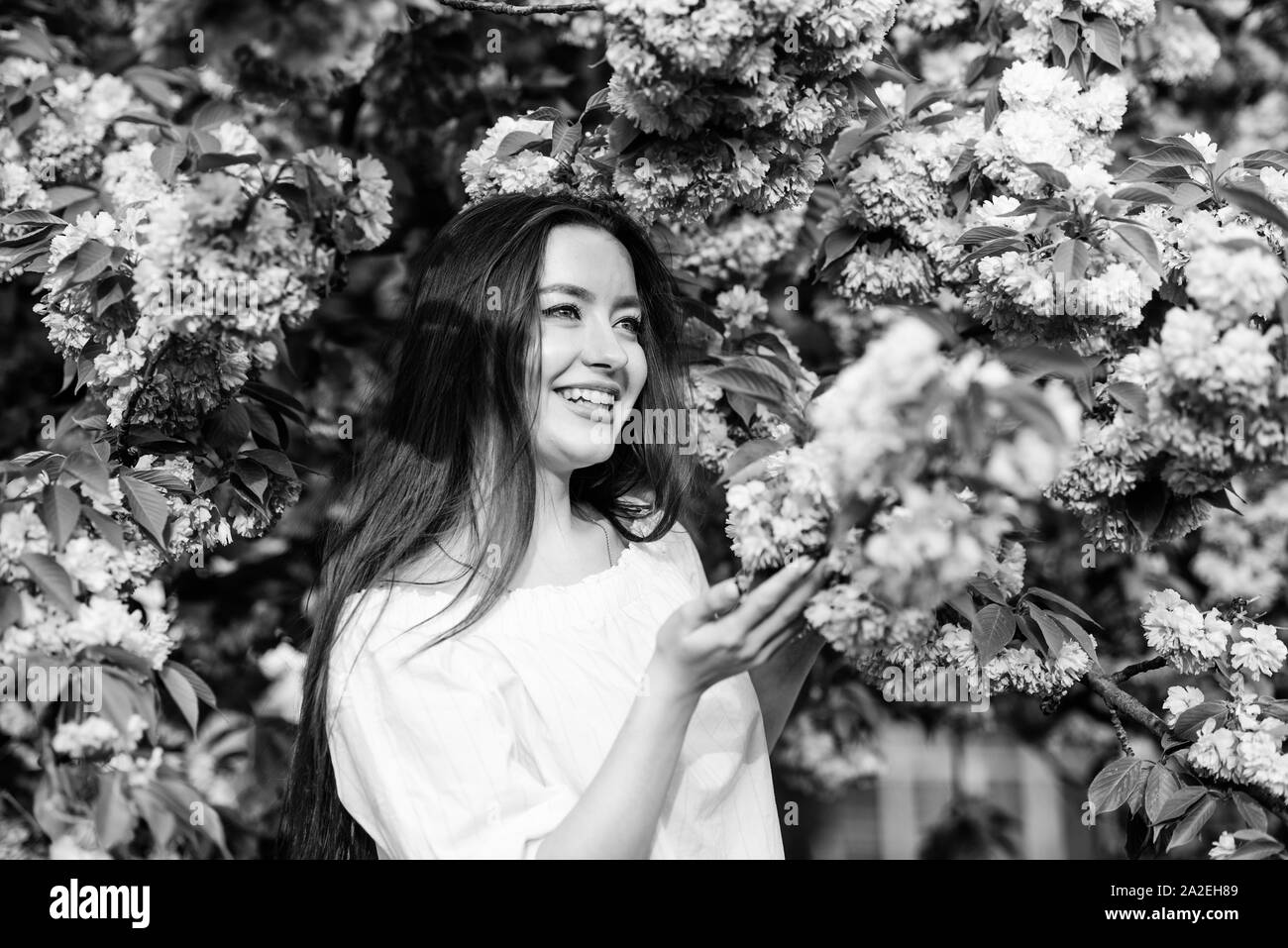 Soft and tender. Gorgeous flower and female beauty. Woman in spring ...