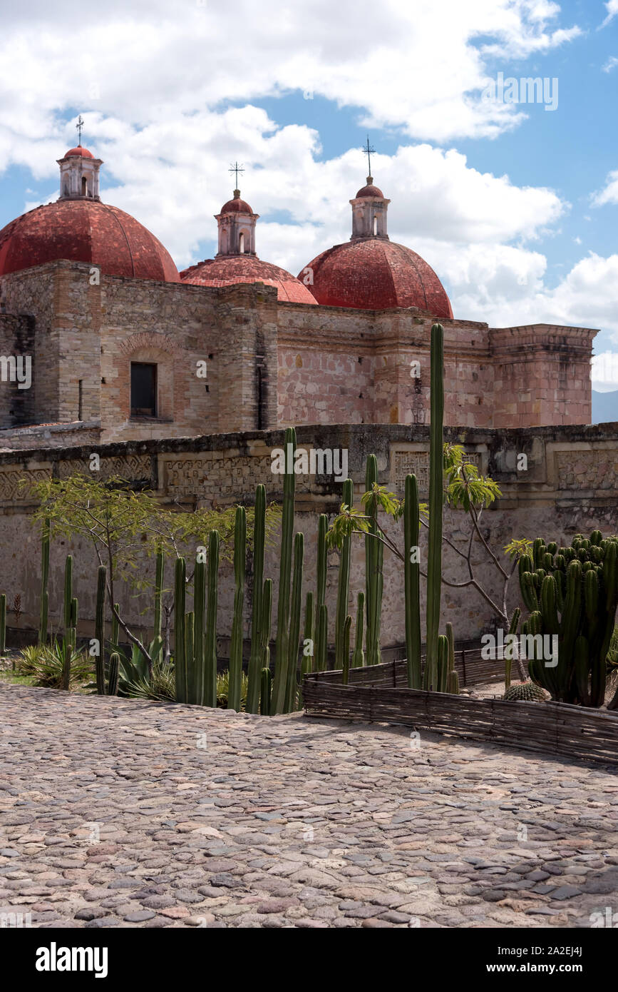 Walls of Zapotec archeological site and the domes of Saint Peter's ...