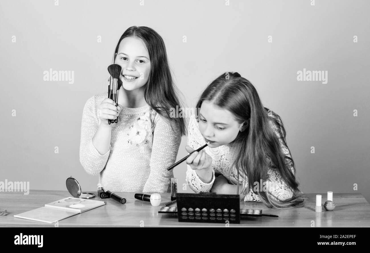 Creating their style with decorative cosmetics. Little girls applying ...