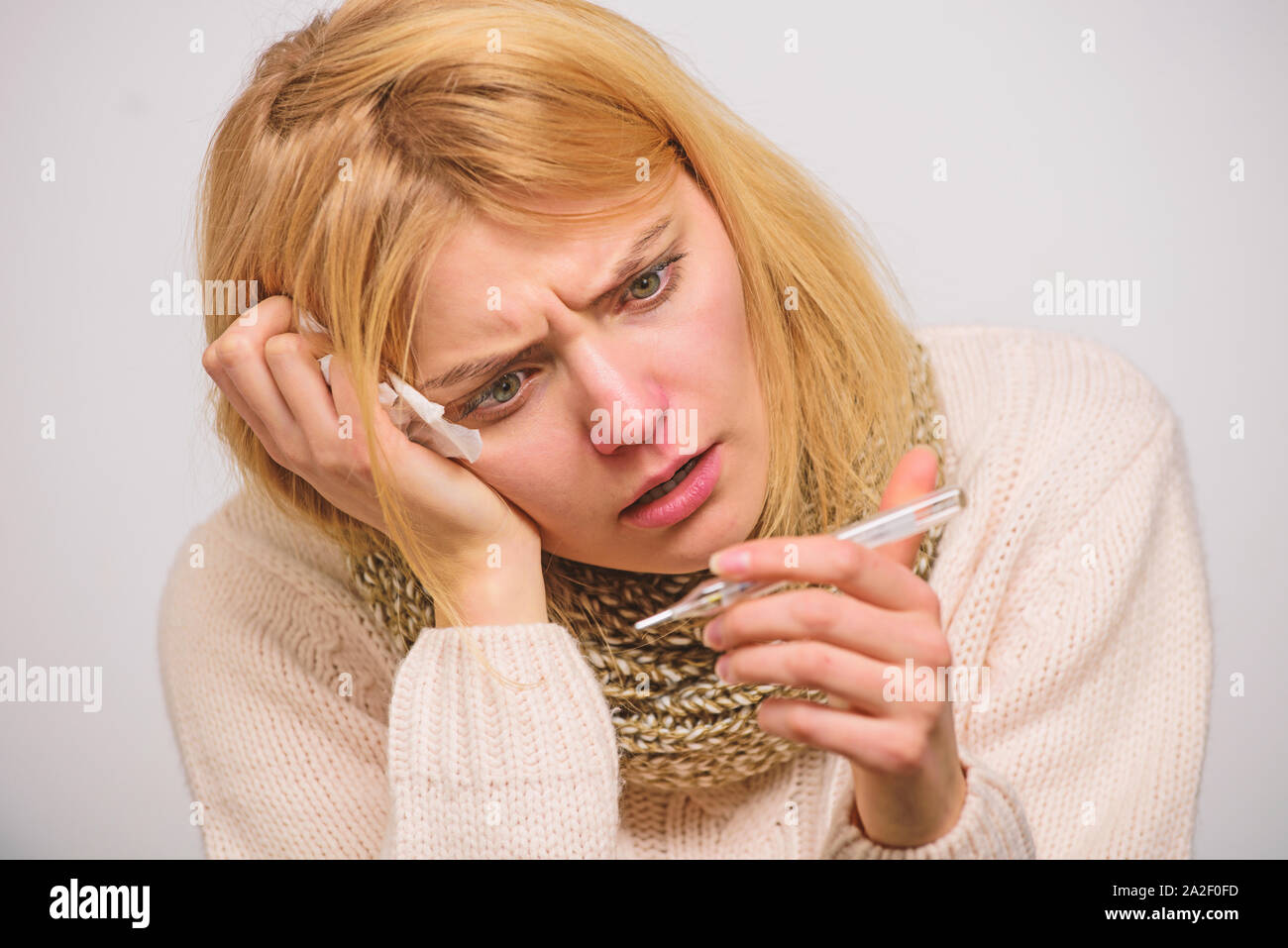 Break fever remedies. Take temperature and assess symptoms. Woman feels ...