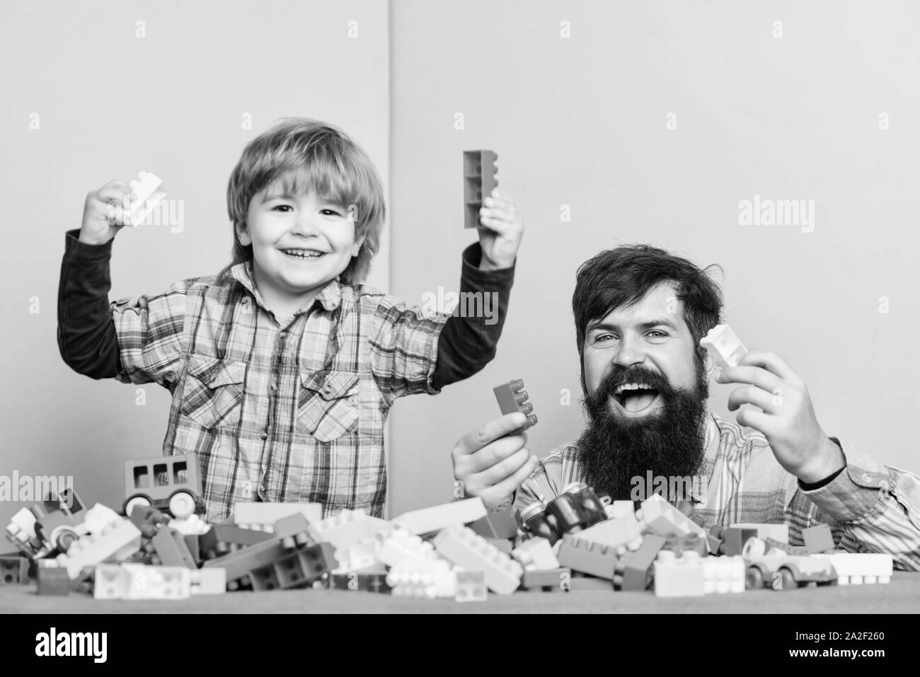 Dad and child build plastic blocks. Happy family. Child development and ...