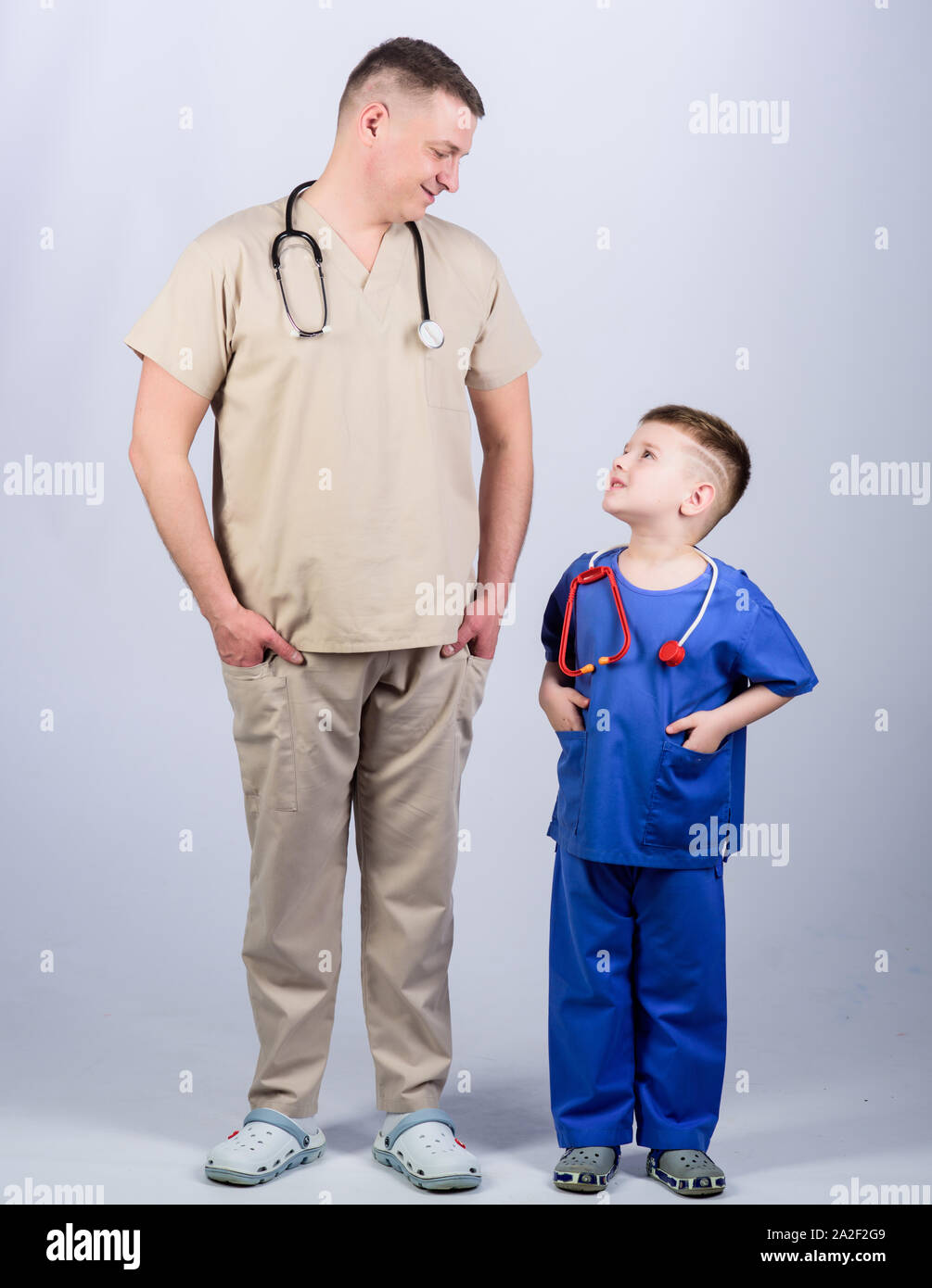 Want to be doctor as dad. Cute kid play doctor game. Family doctor ...