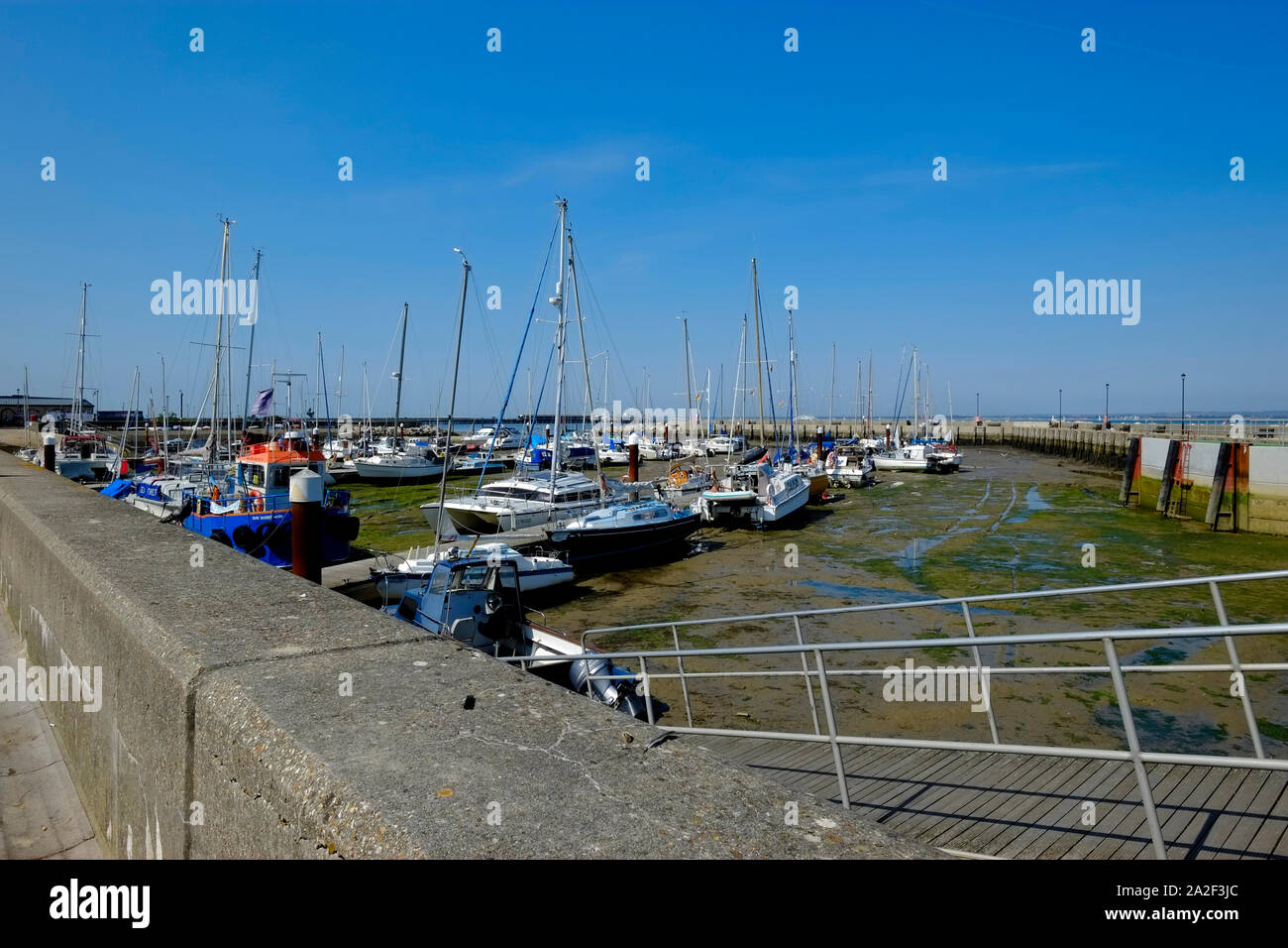 Ryde Harbour on the Isle of Wight at low tide showing yachts and motor ...