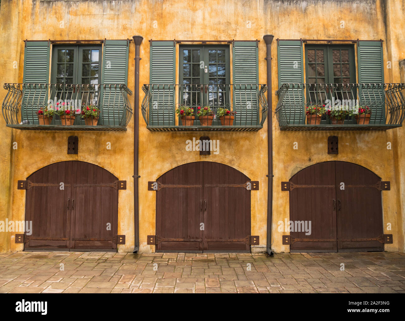 Italian style two-story building with doors and terrace balcony above ...