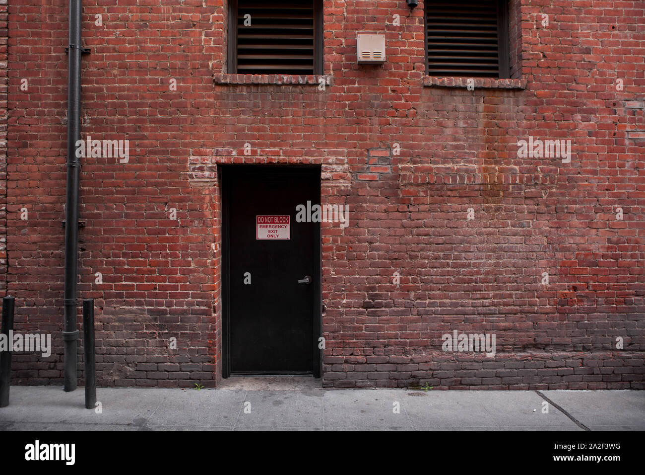 Back door entrance to an old brick building from the alley Stock Photo ...